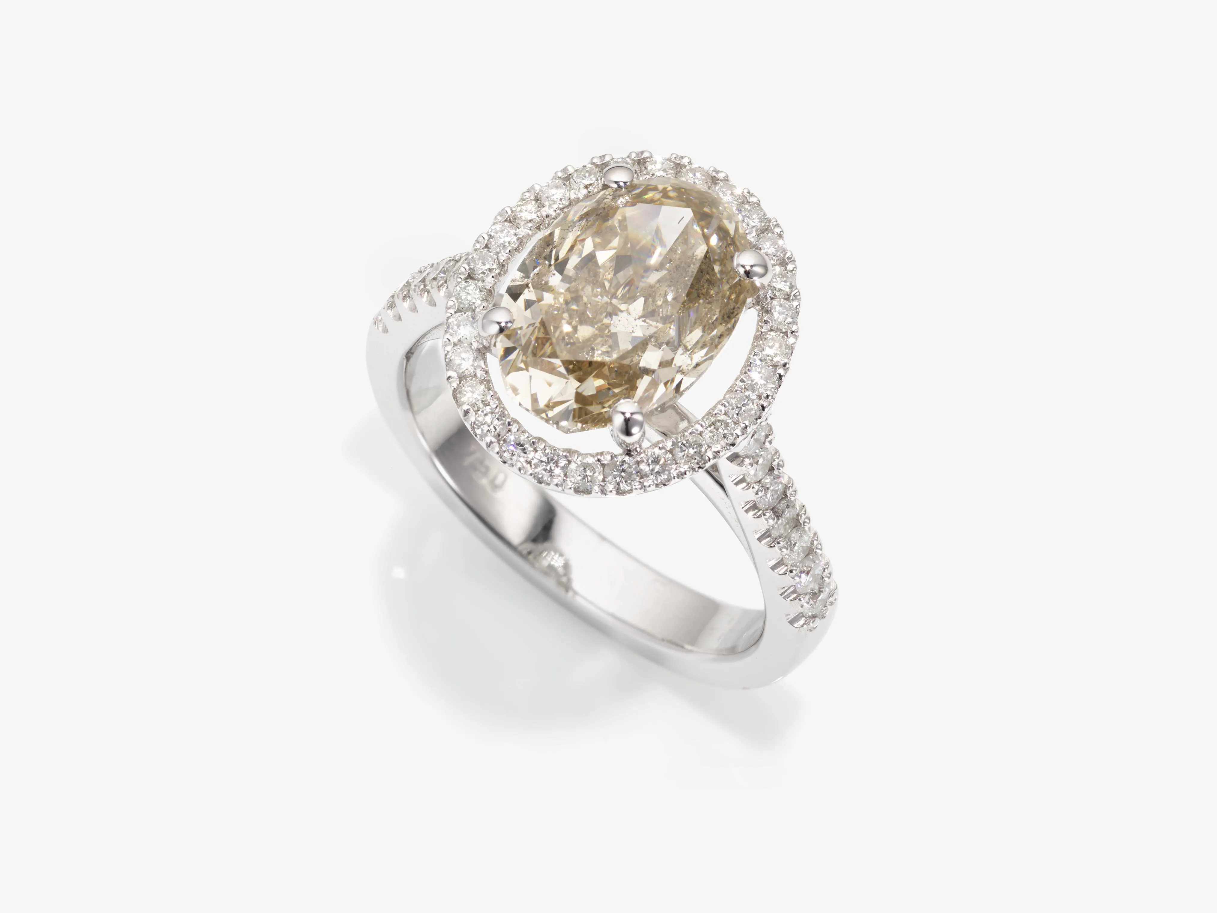 A classic modern cocktail ring decorated with an oval diamond and ...