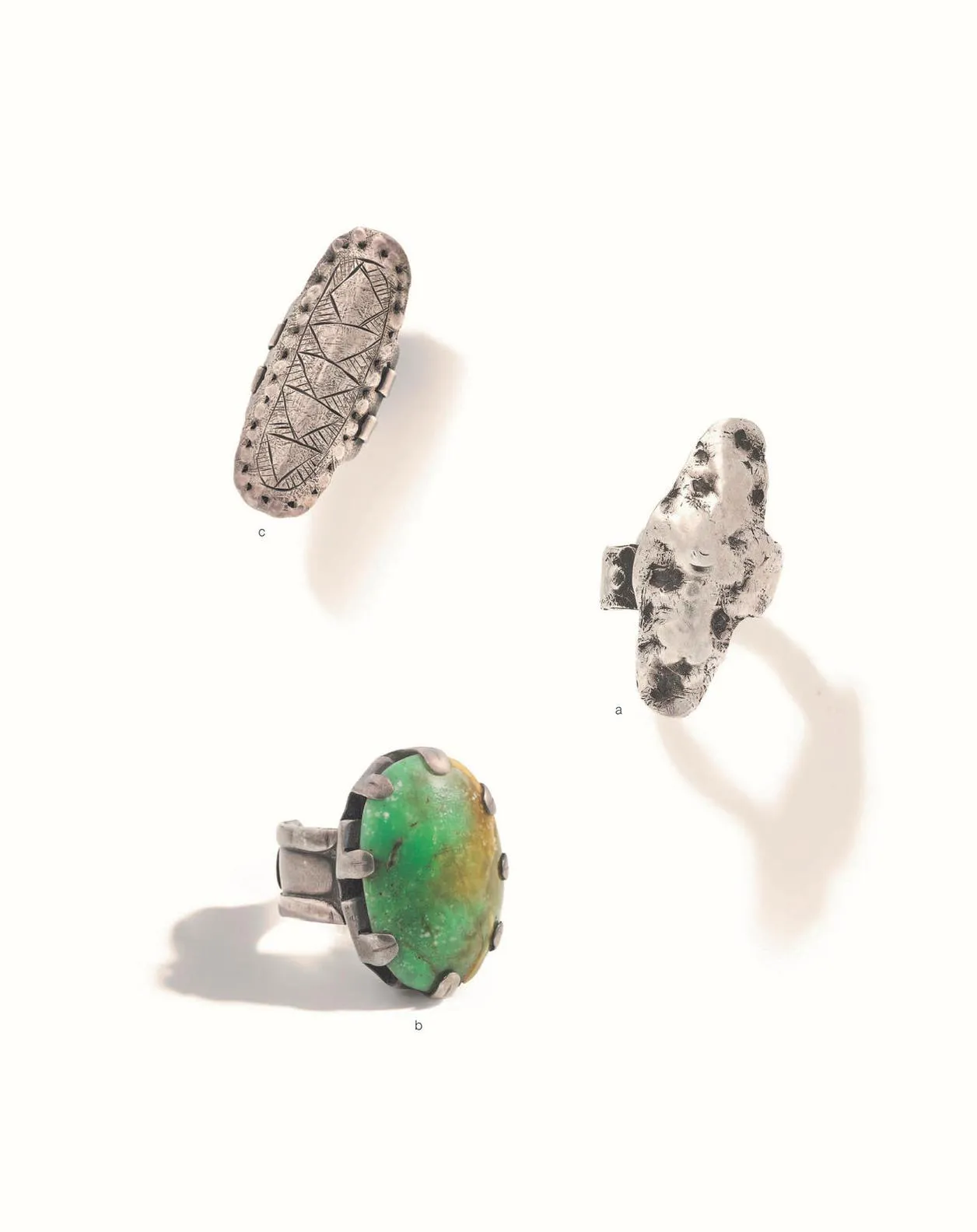 (i) A Shield-Shaped Hammered Silver Ring, 1910-1911; (ii) A silver ring ...